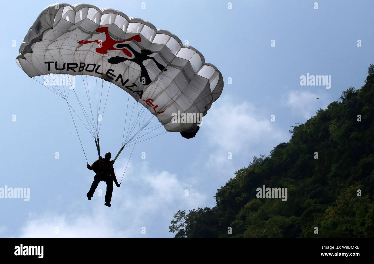 A contestant jumps off the glass cantilever bridge on the cliff during ...