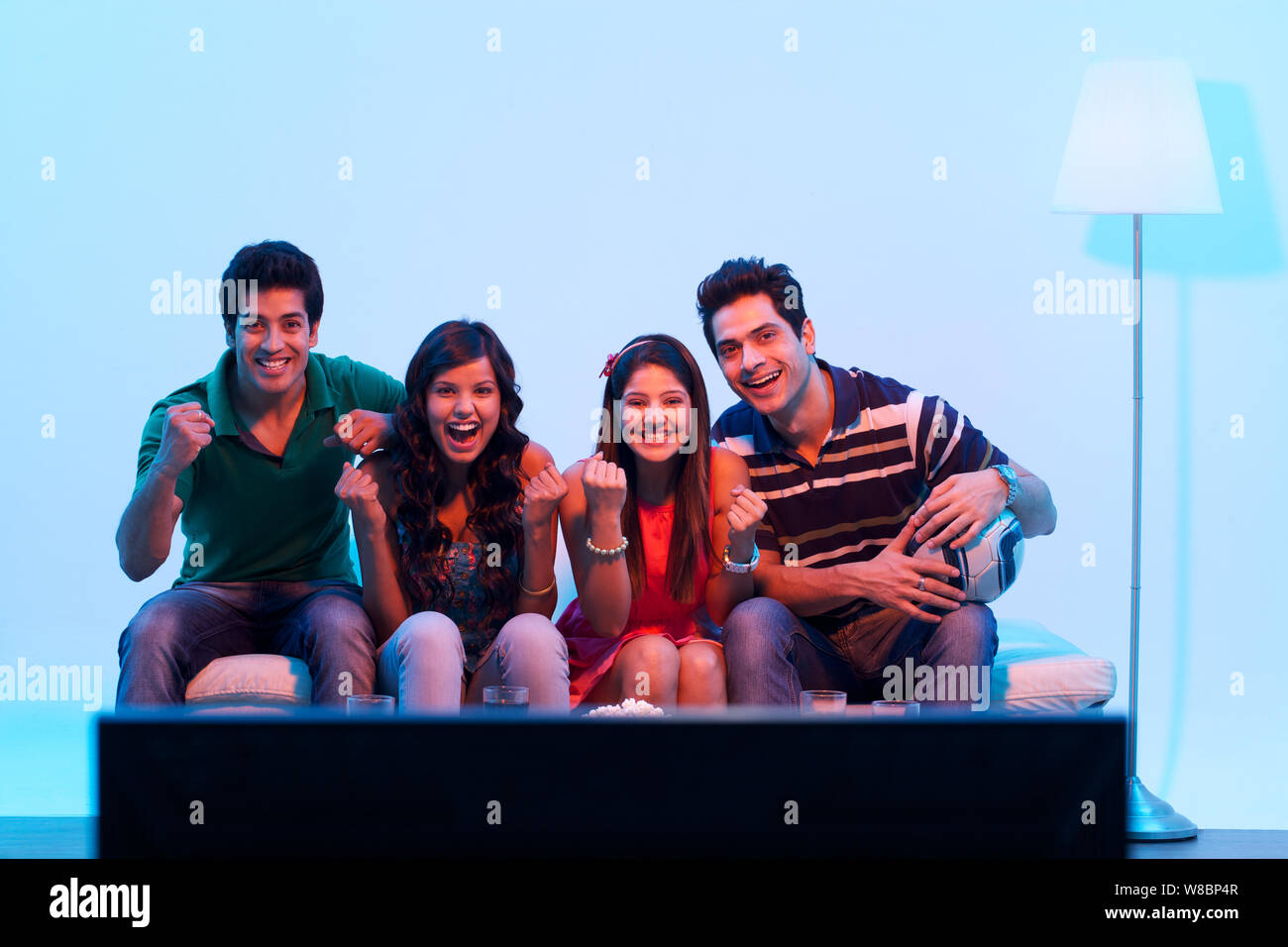 Small group friends watching tv hi-res stock photography and images - Alamy