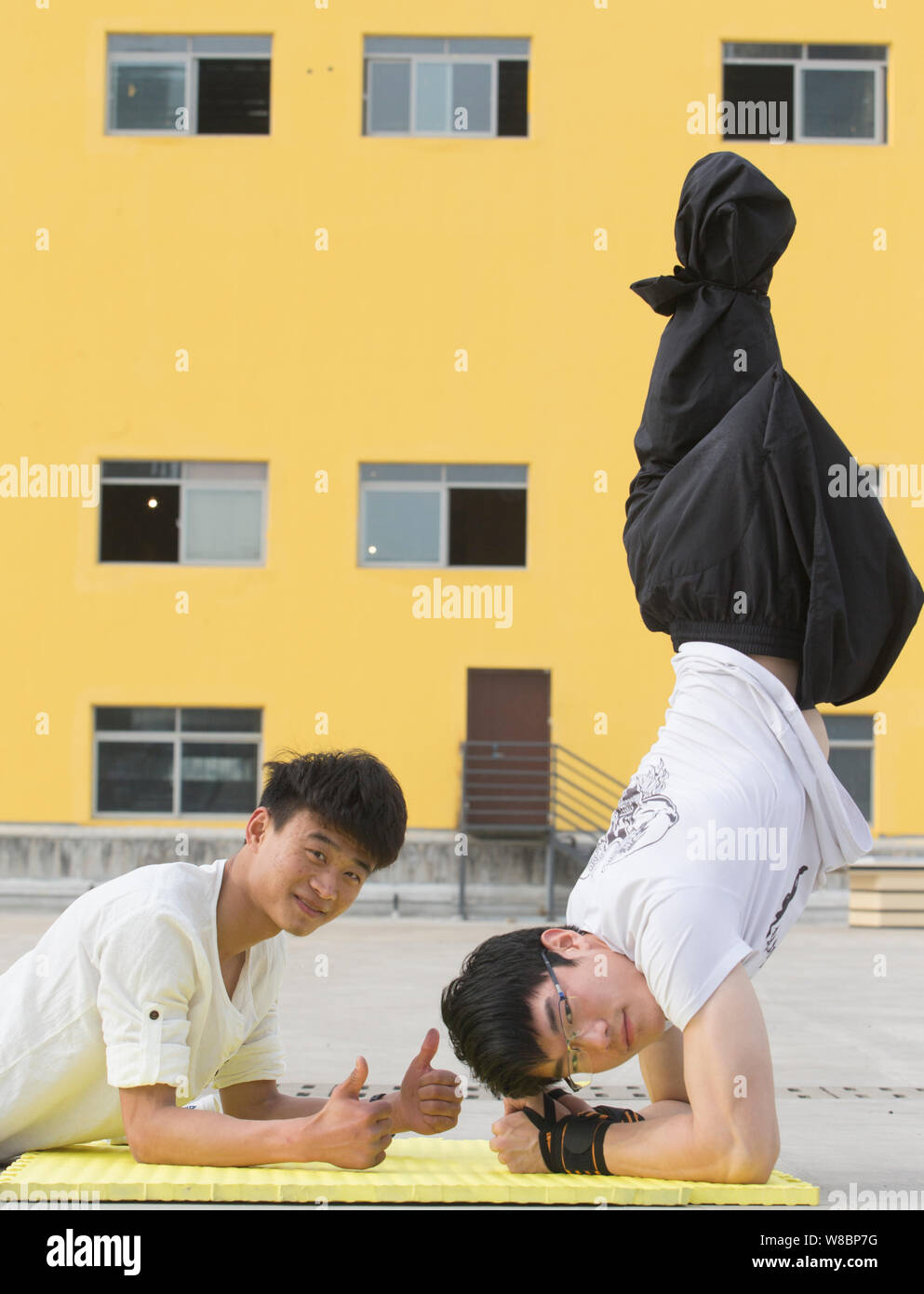 Legless Chinese man Shen Dacheng, right, supports his body with two ...