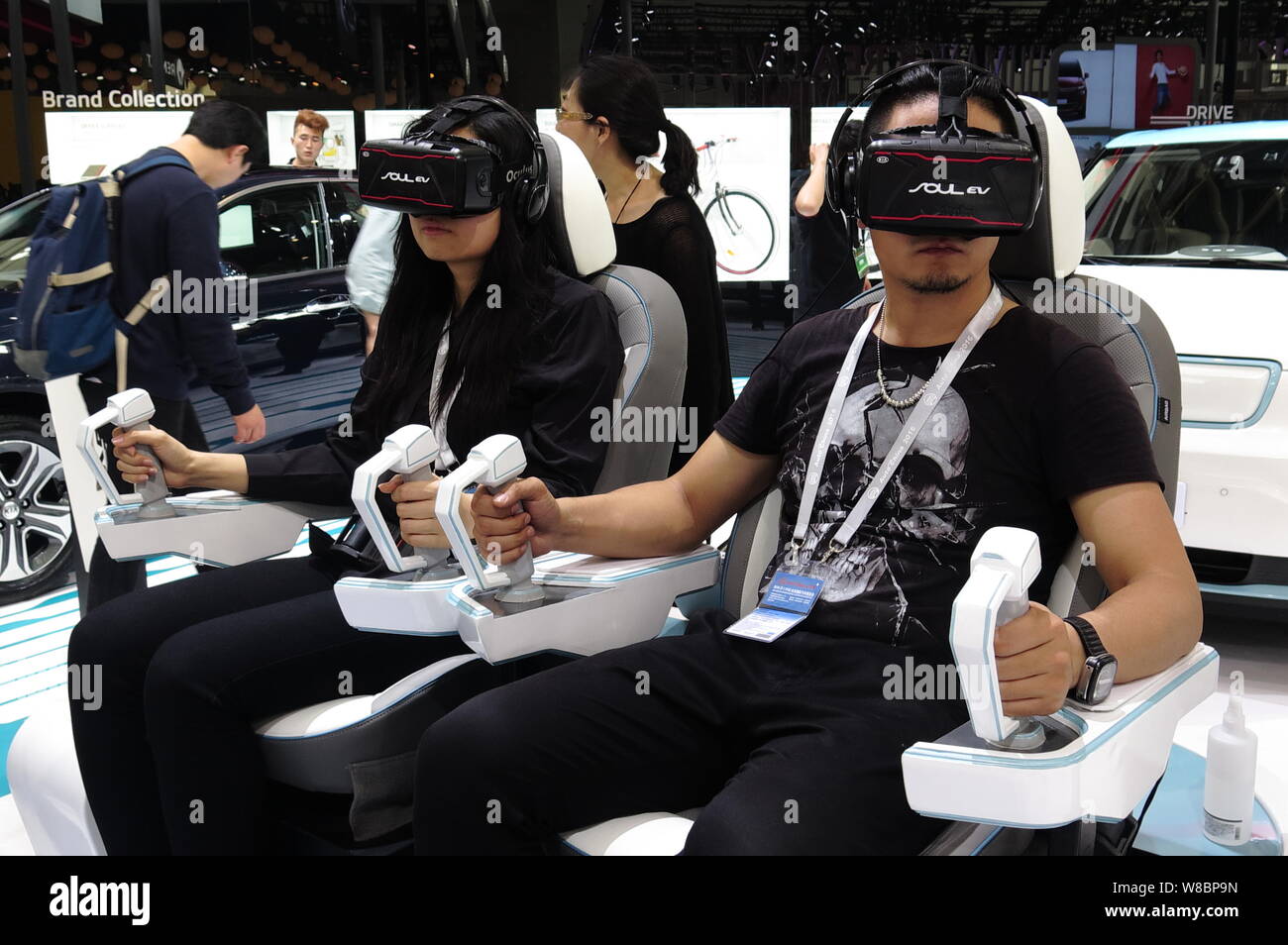 Visitors try out virtual reality (VR) devices during the 14th Beijing ...