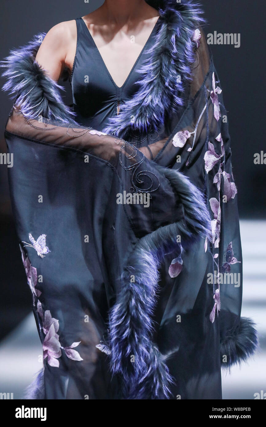 A model displays a new creation at a fashion show of Woo during the ...