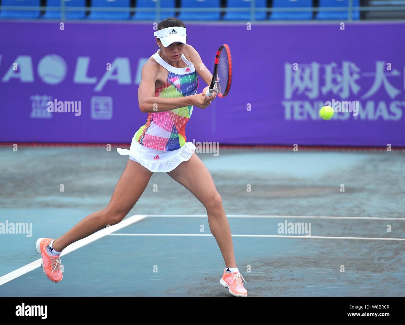 Xu Shilin of China returns a shot to Riko Sawayanagi of Japan in their ...