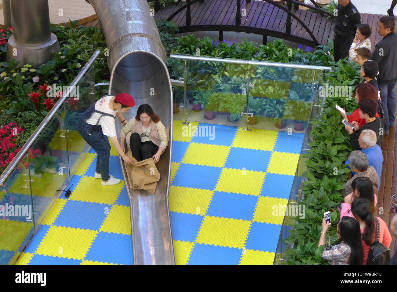 A woman tries out the five-story-high giant winding slide during a ...