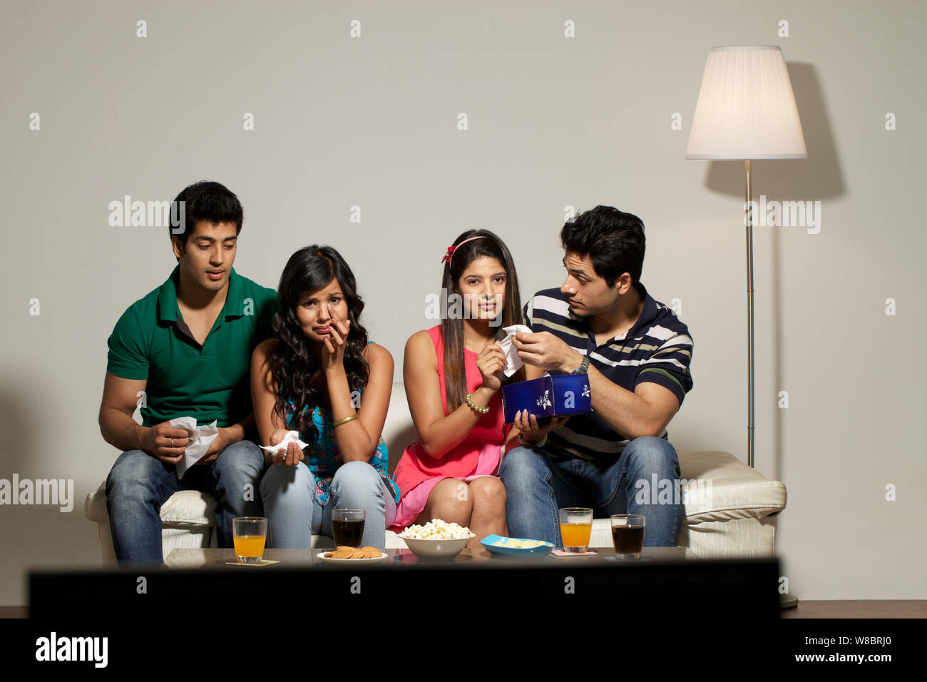 Friends watching a sad film Stock Photo - Alamy