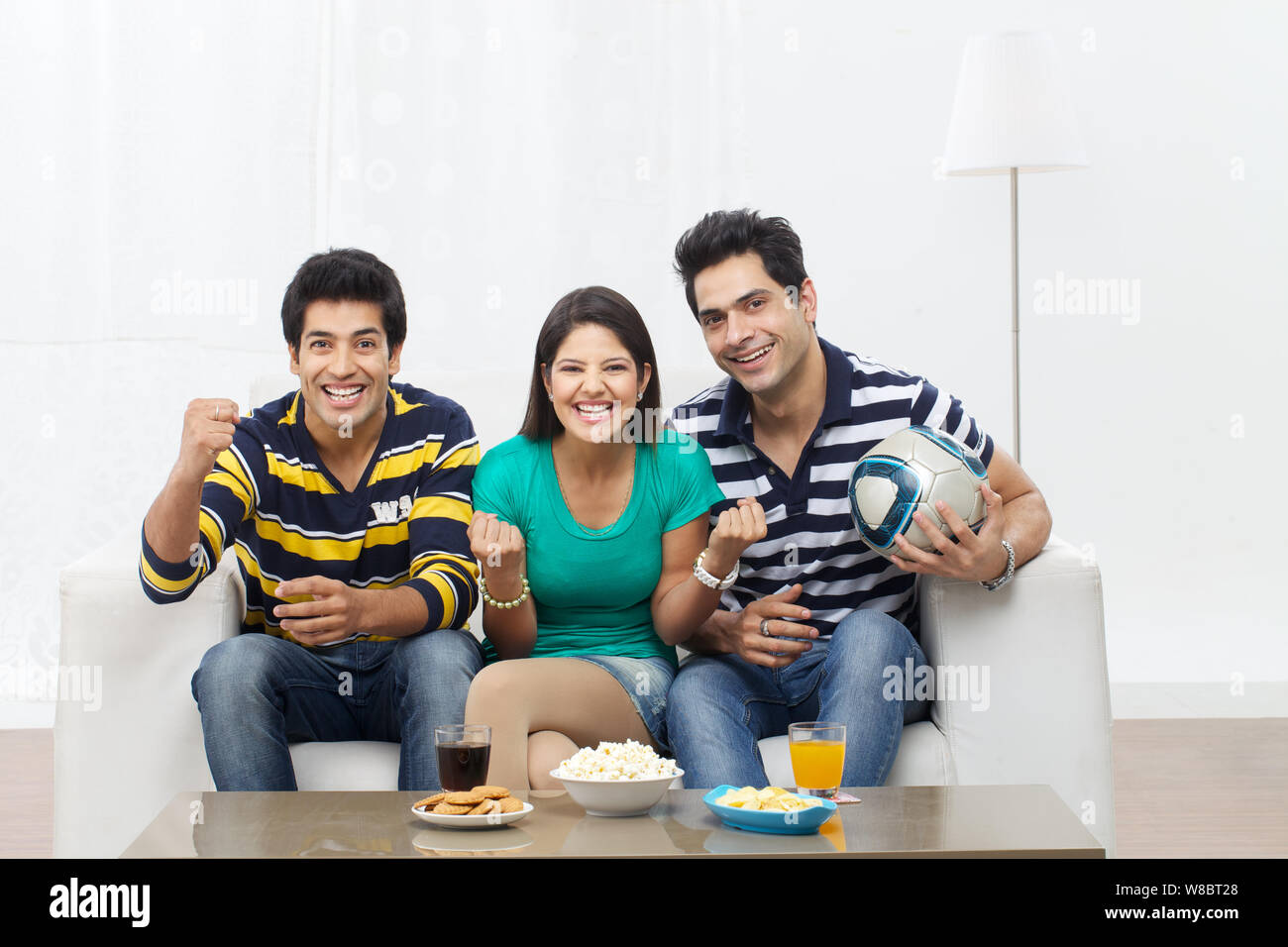 Small group friends watching tv hi-res stock photography and images - Alamy