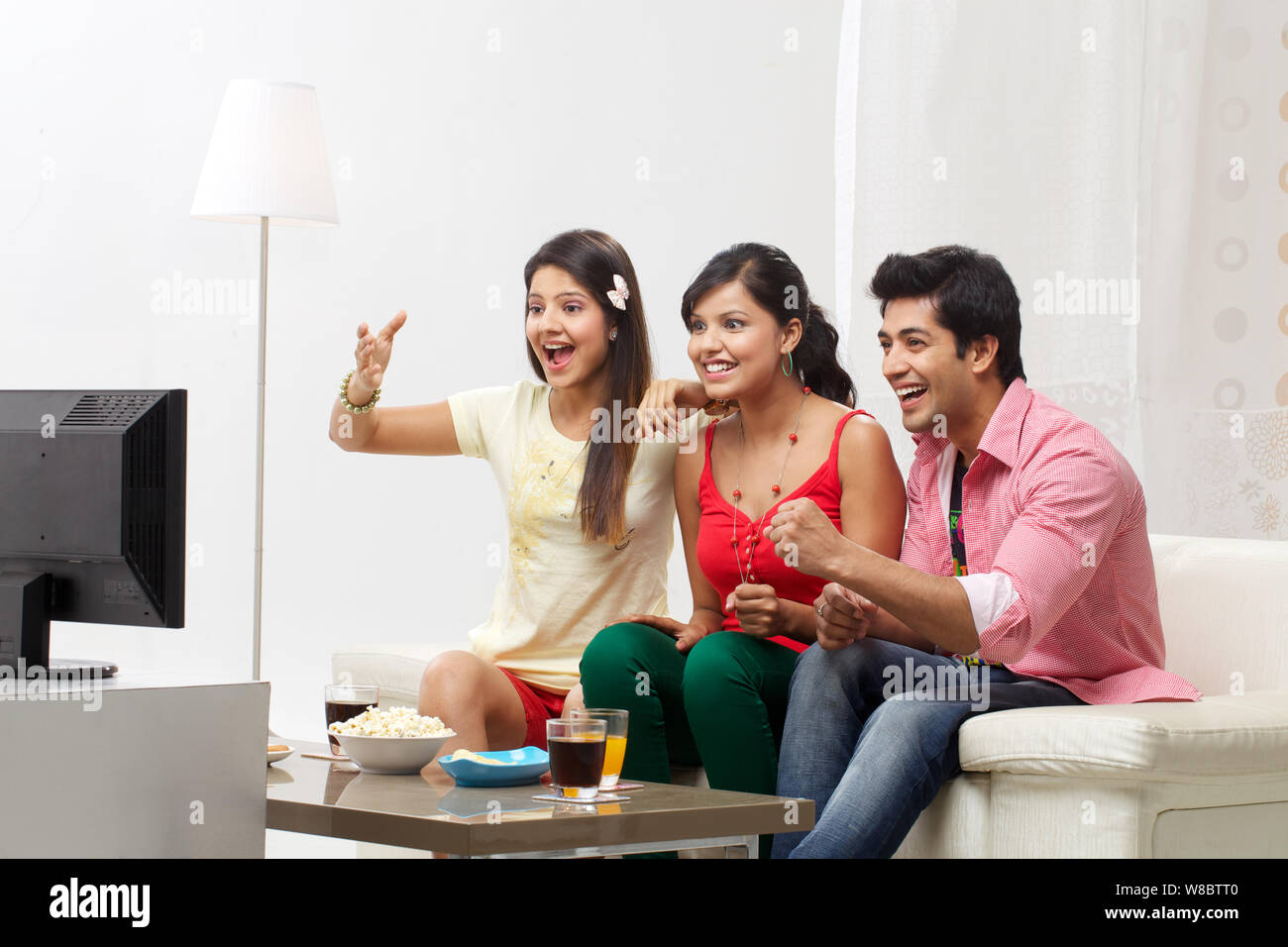Small group friends watching tv hi-res stock photography and images - Alamy