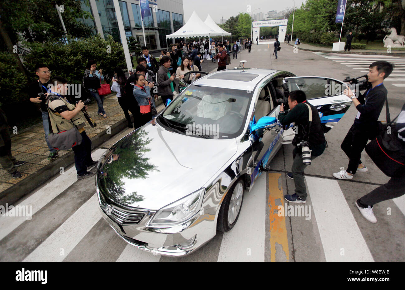 People take pictures of a self-driving car produced by Changan which ...