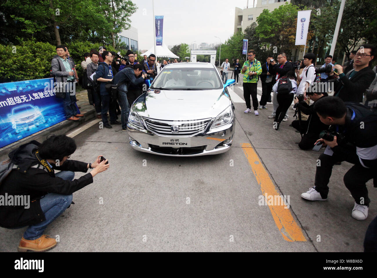 People take pictures of a self-driving car produced by Changan which ...