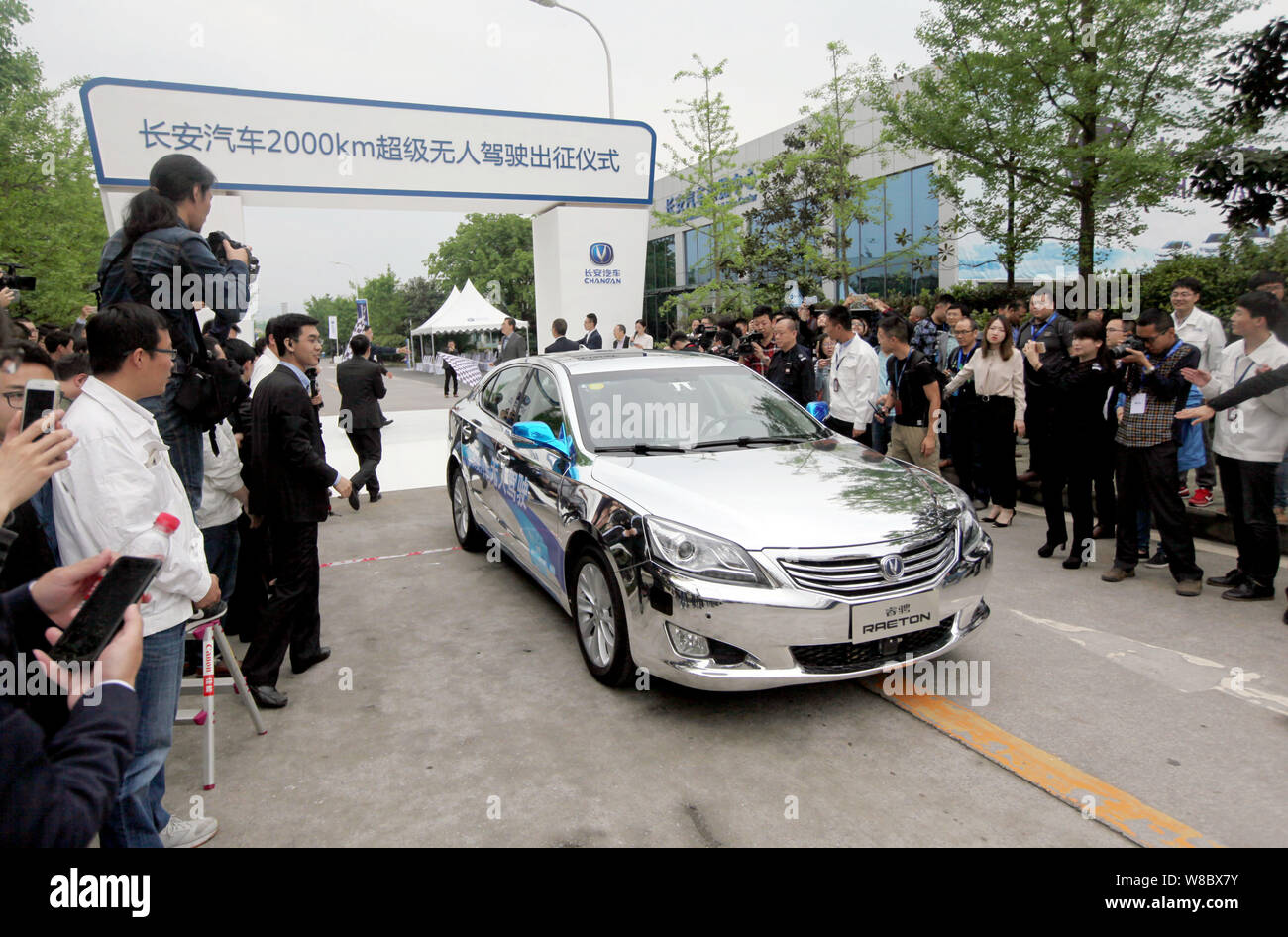 People take pictures of a self-driving car produced by Changan which ...