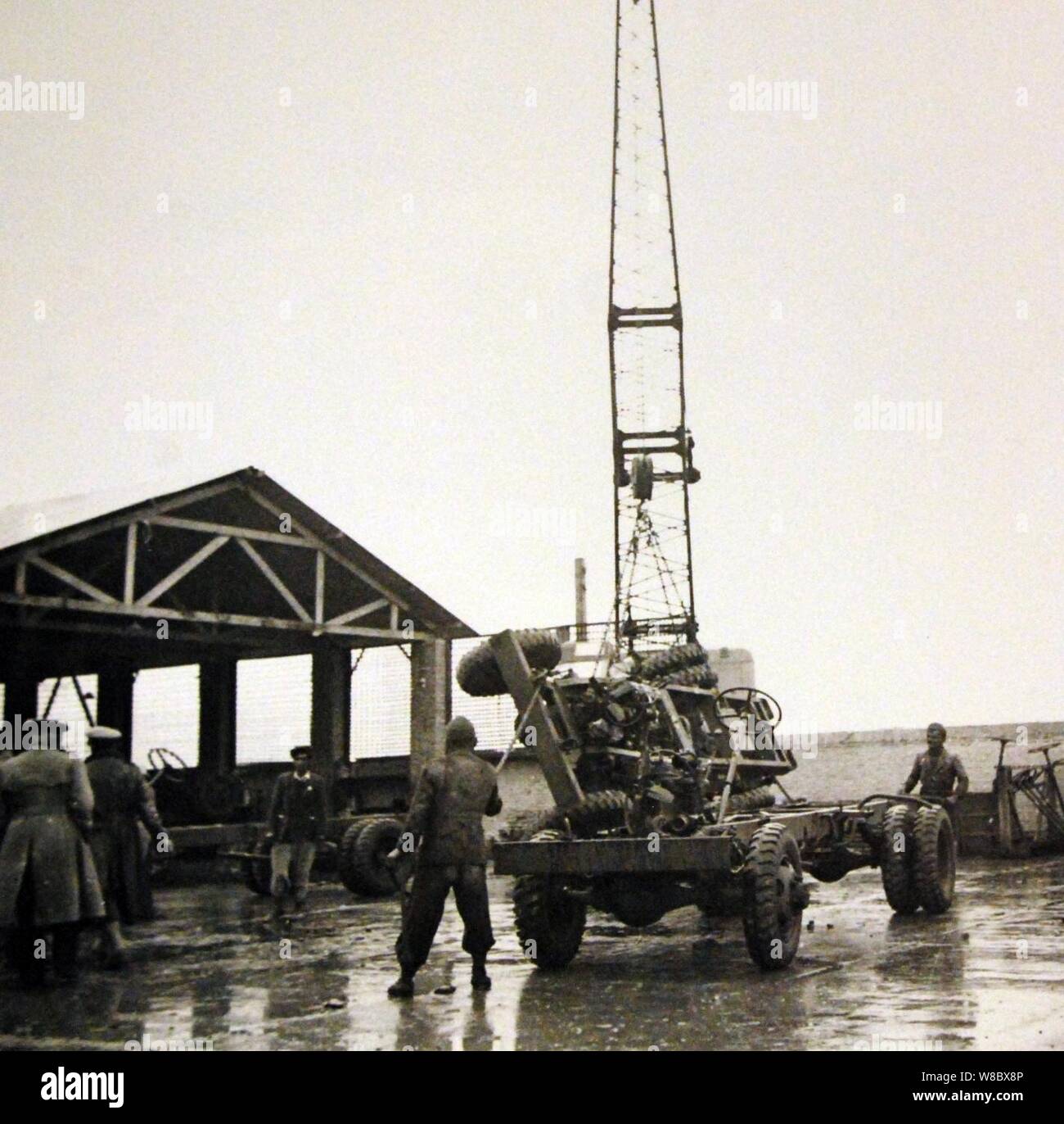 Derrick moving a truck chassis in rain, American truck assembly plant ...