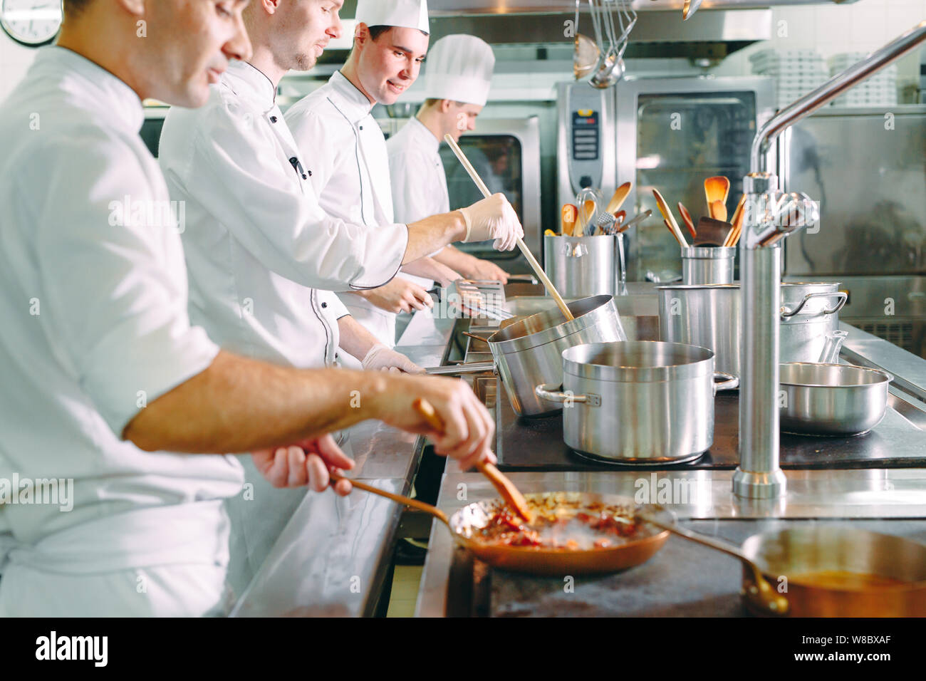 Chef cooking vegetables in wok pan. Shallow dof Stock Photo - Alamy