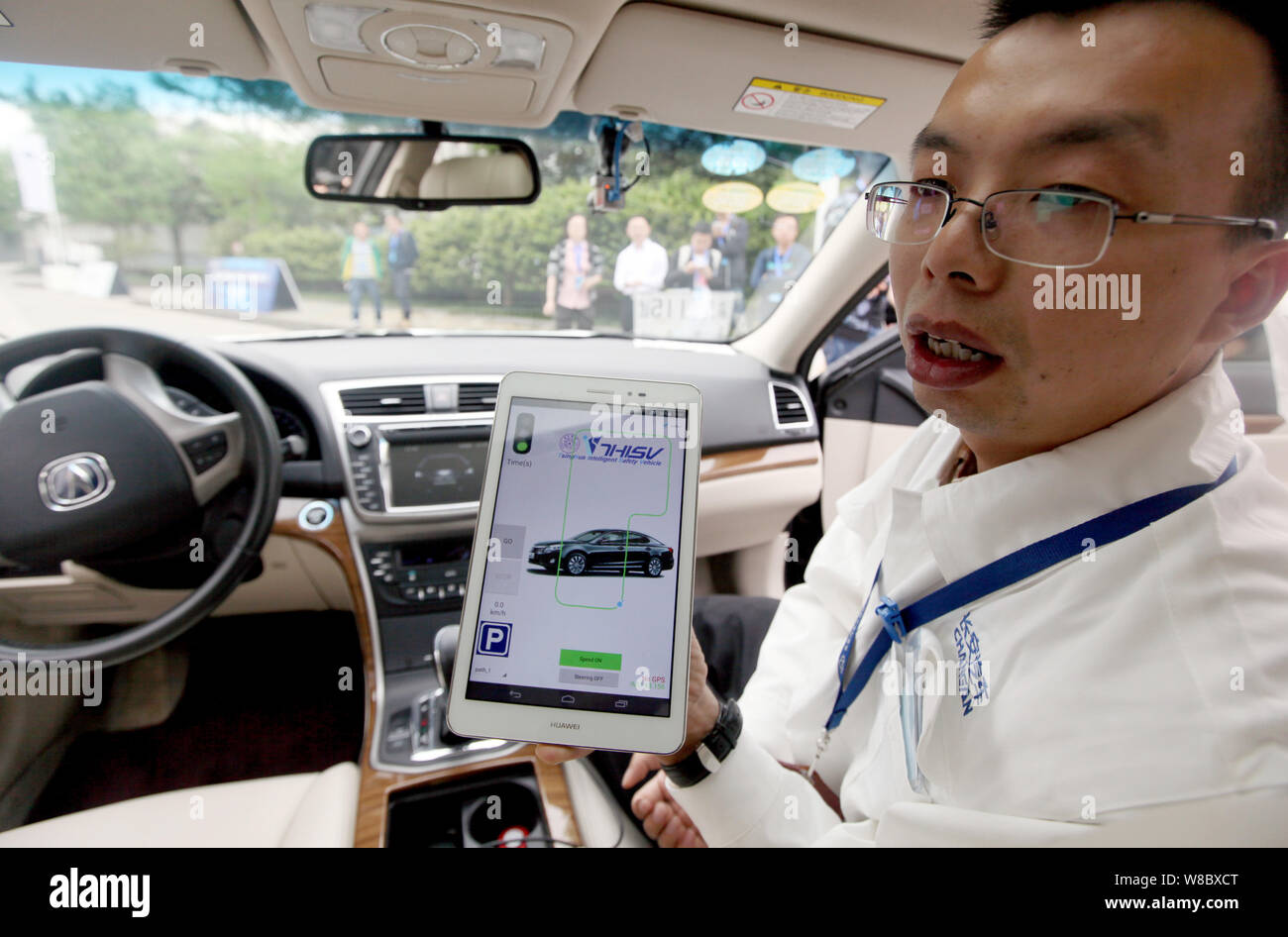 A Chinese employee of Changan Automobile shows a control app on a ...