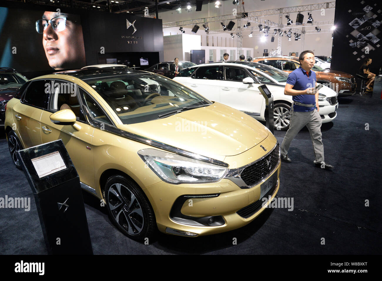--FILE--A visitor walks past DS cars of PSA on display during an auto ...