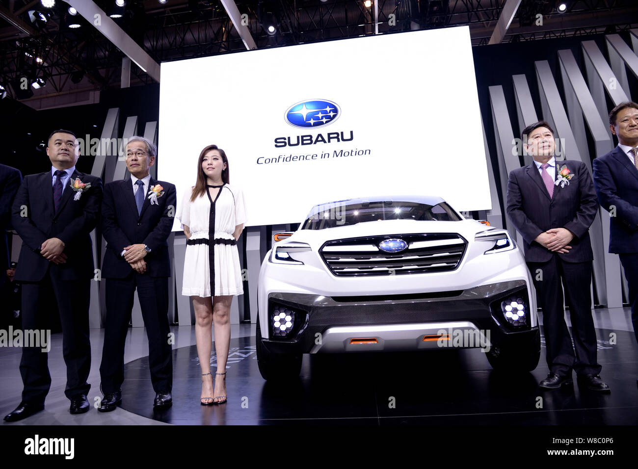 Chinese singer Zhang Liangying, third left, poses with a Subaru Viziv ...