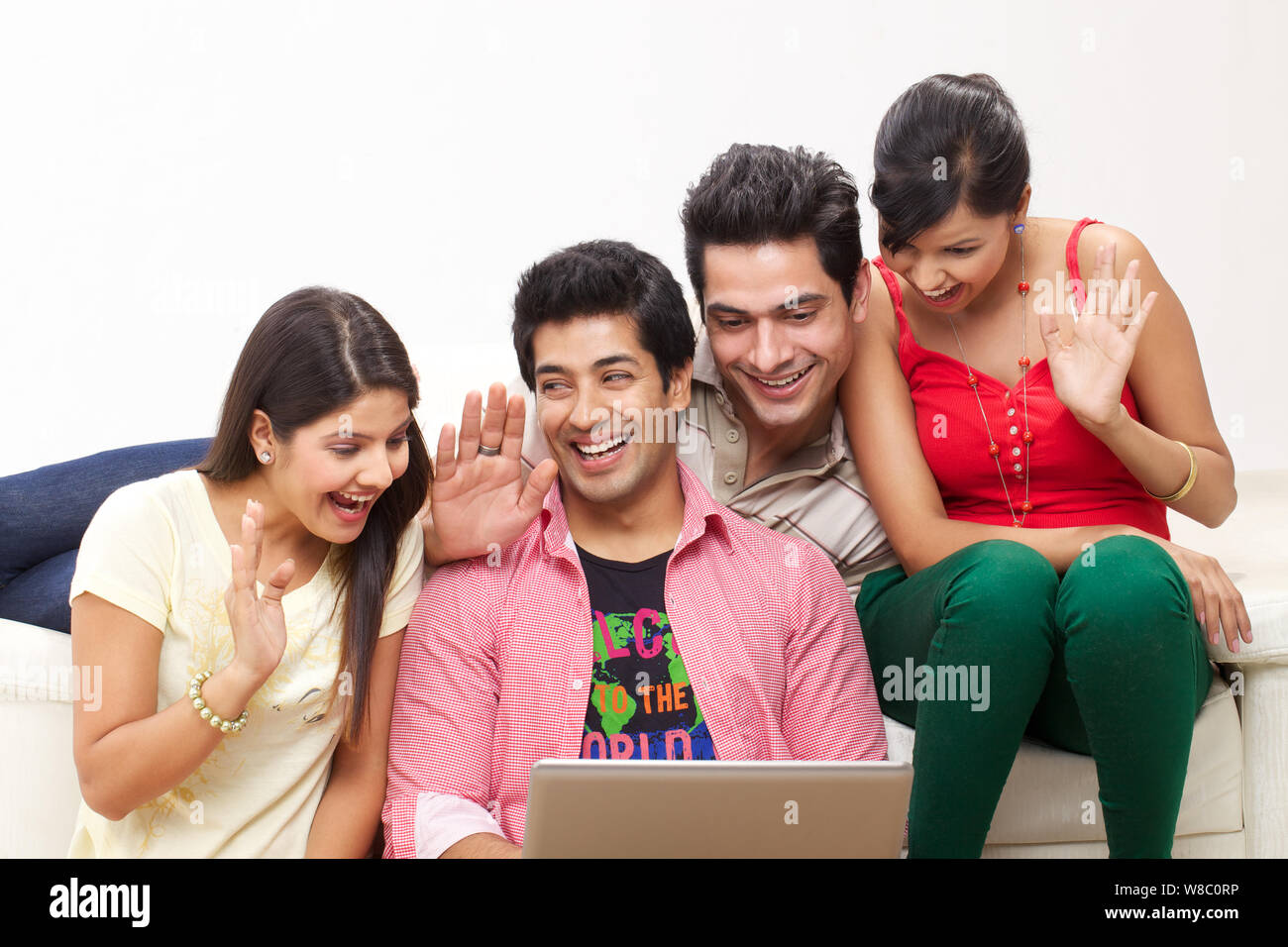 Friends using laptop Stock Photo - Alamy