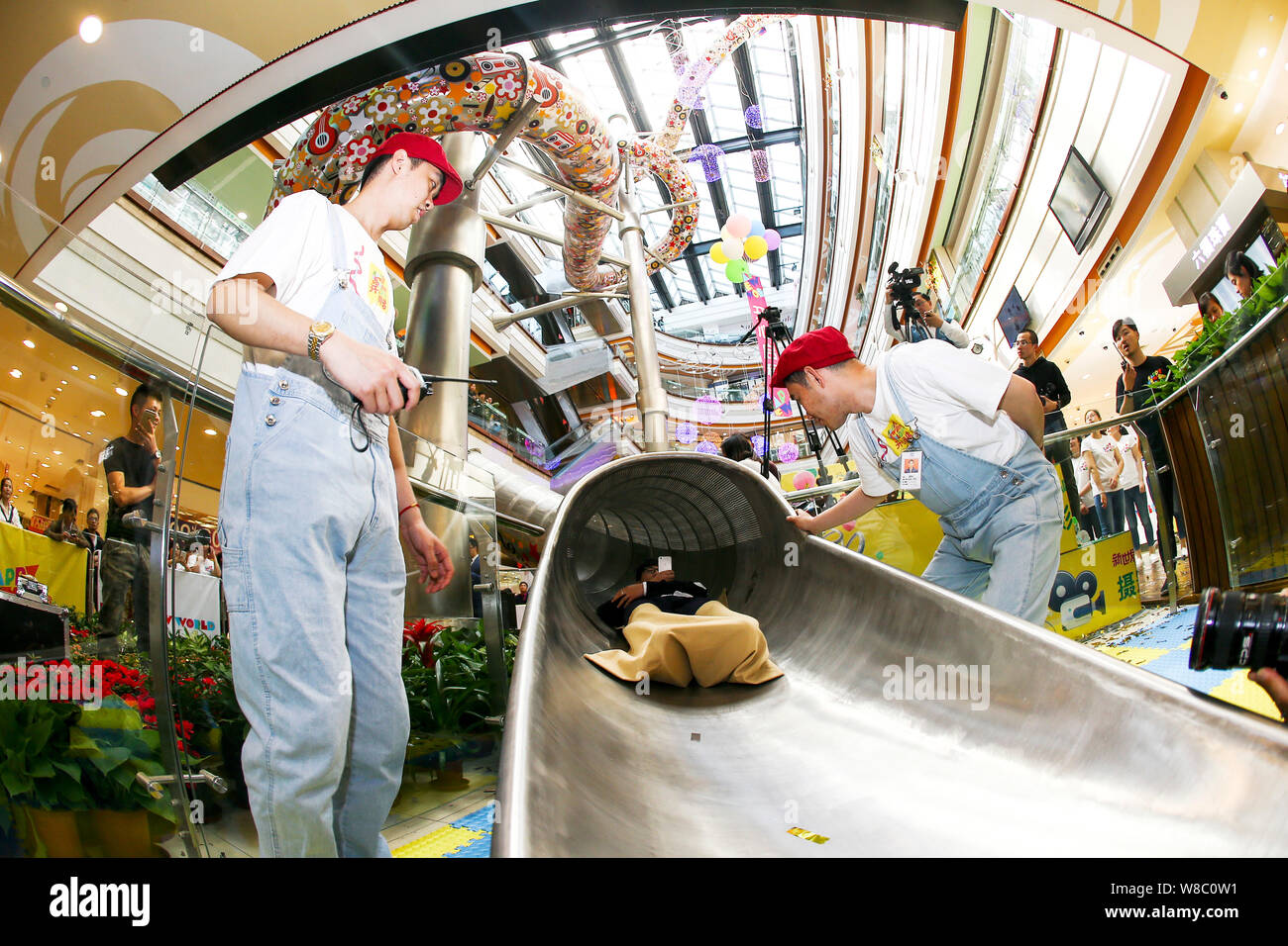 A man tries out the five-story-high giant winding slide during a trial ...