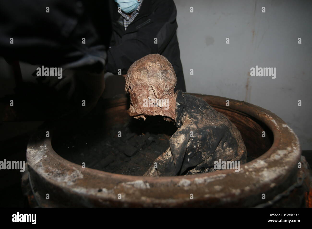 Workers prepare to carry the mummified Buddhist monk Fu Hou or Fuhou ...