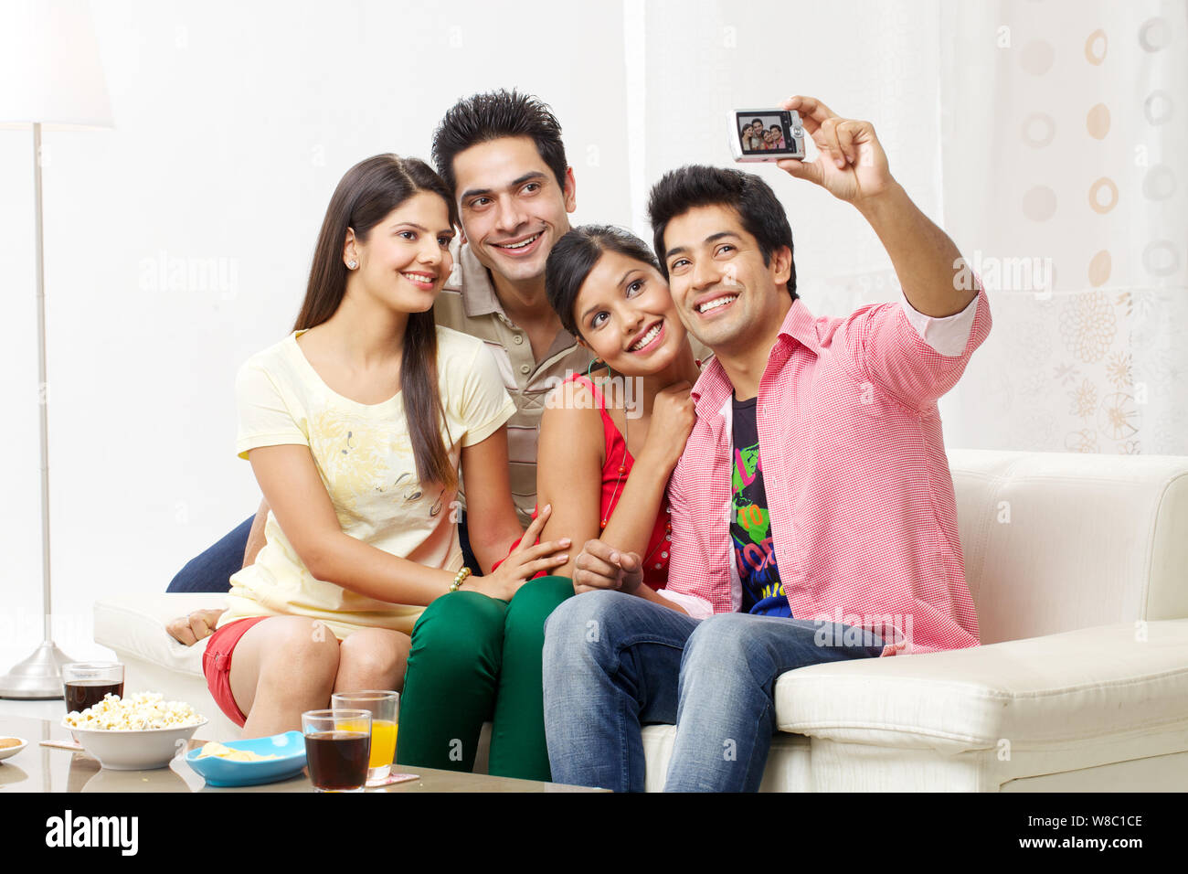 Friends taking picture of themselves with a digital camera Stock Photo ...