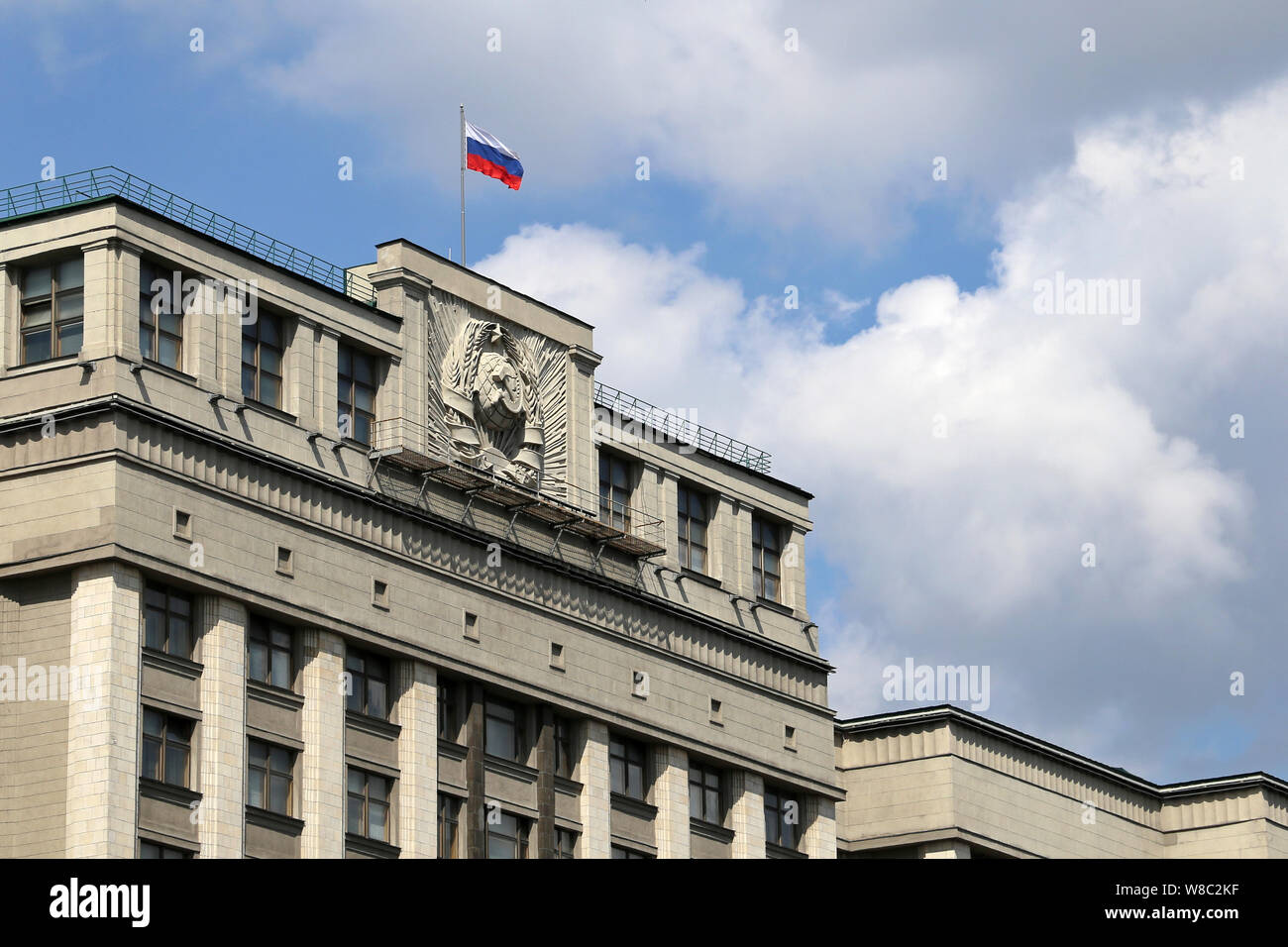 Russian flag on the parliament building in Moscow on background of blue ...