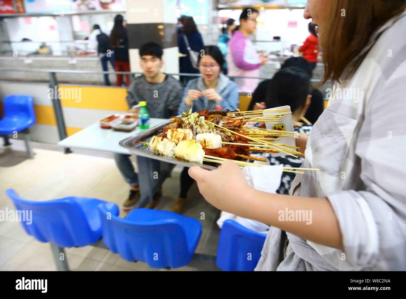 A customer buys food at the outdoor campus food stalls in Tongji ...