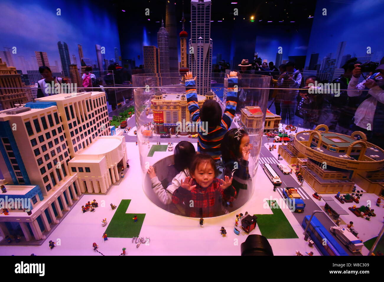 Visitors look at Shanghai's landmark buildings made with Lego bricks at ...