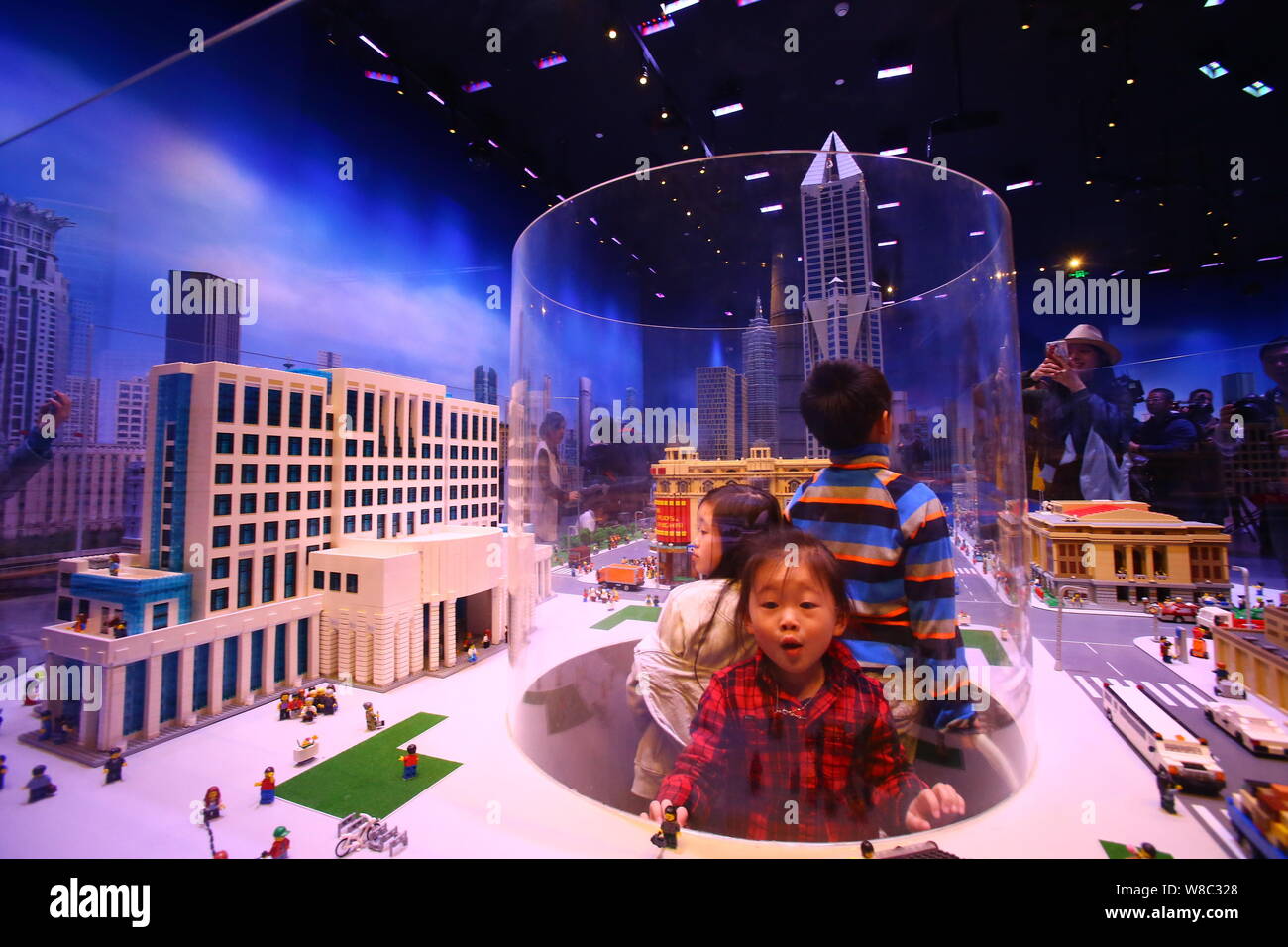 Visitors look at Shanghai's landmark buildings made with Lego bricks at ...