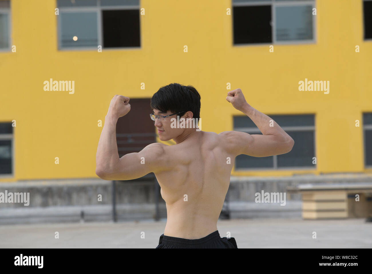 Legless Chinese man Shen Dacheng shows his muscles during a training ...