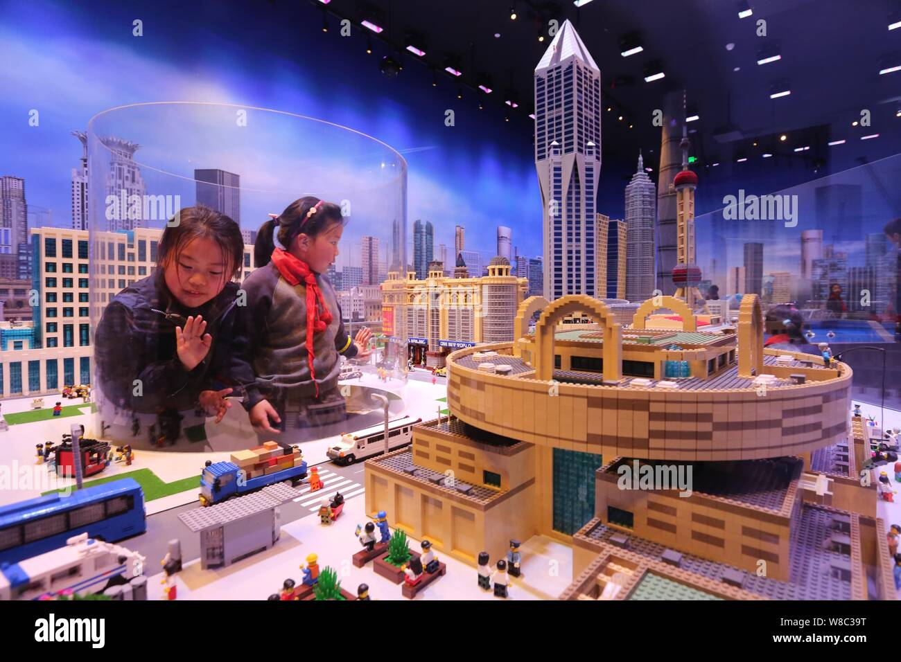 Visitors look at Shanghai's landmark buildings made with Lego bricks at ...