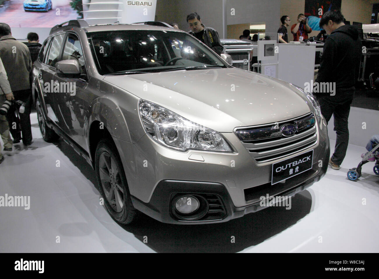 --FILE--Visitors look at a Subaru Outback on display during the 13th ...