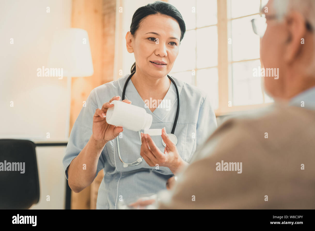 Female doctor with special equipment on her neck Stock Photo - Alamy