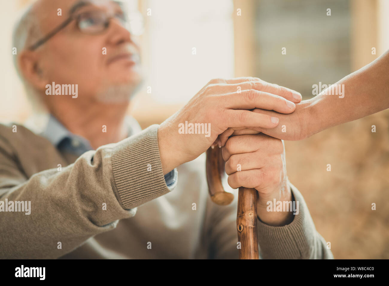 Afraid old man looking on his nurse with hope Stock Photo - Alamy