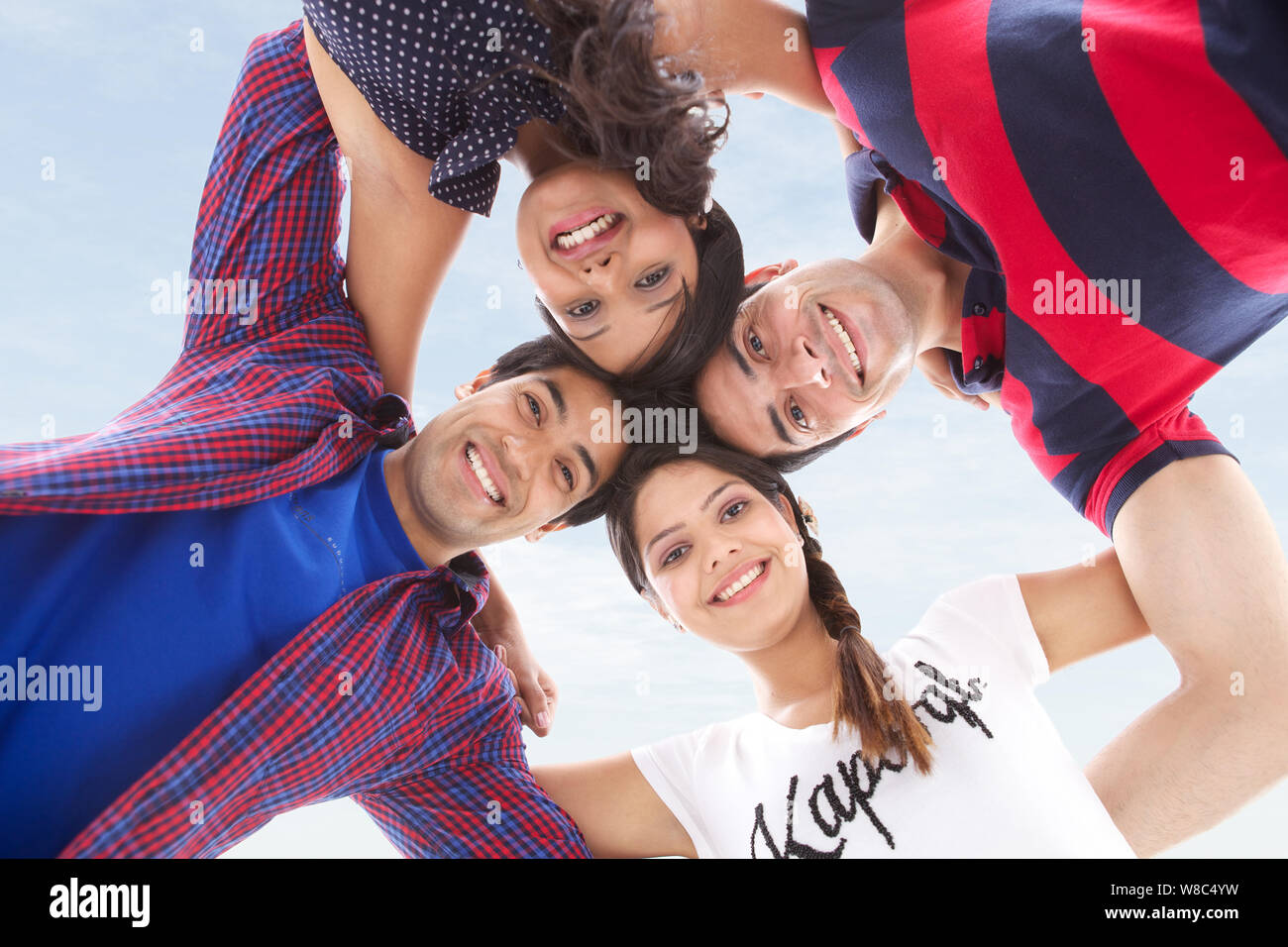 Group of friends smiling in a huddle Stock Photo - Alamy
