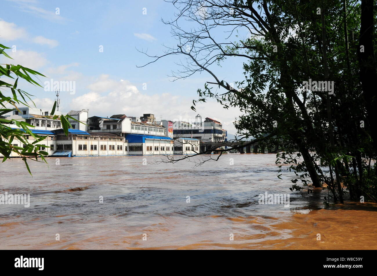 Buildings and trees are partly submerged by floods caused by heavy rain ...