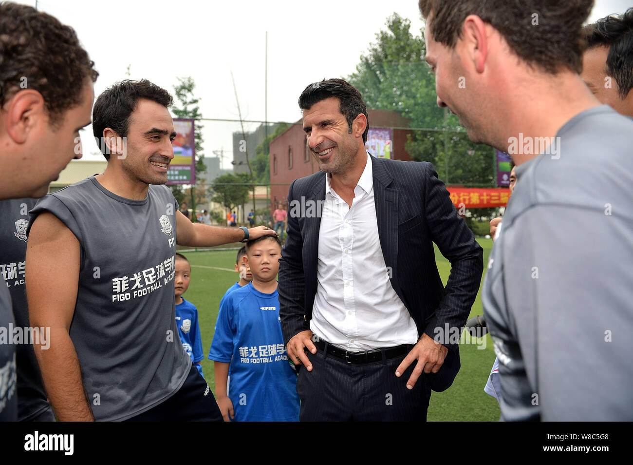 Portuguese football star Luis Figo, center, smiles as he talks with ...