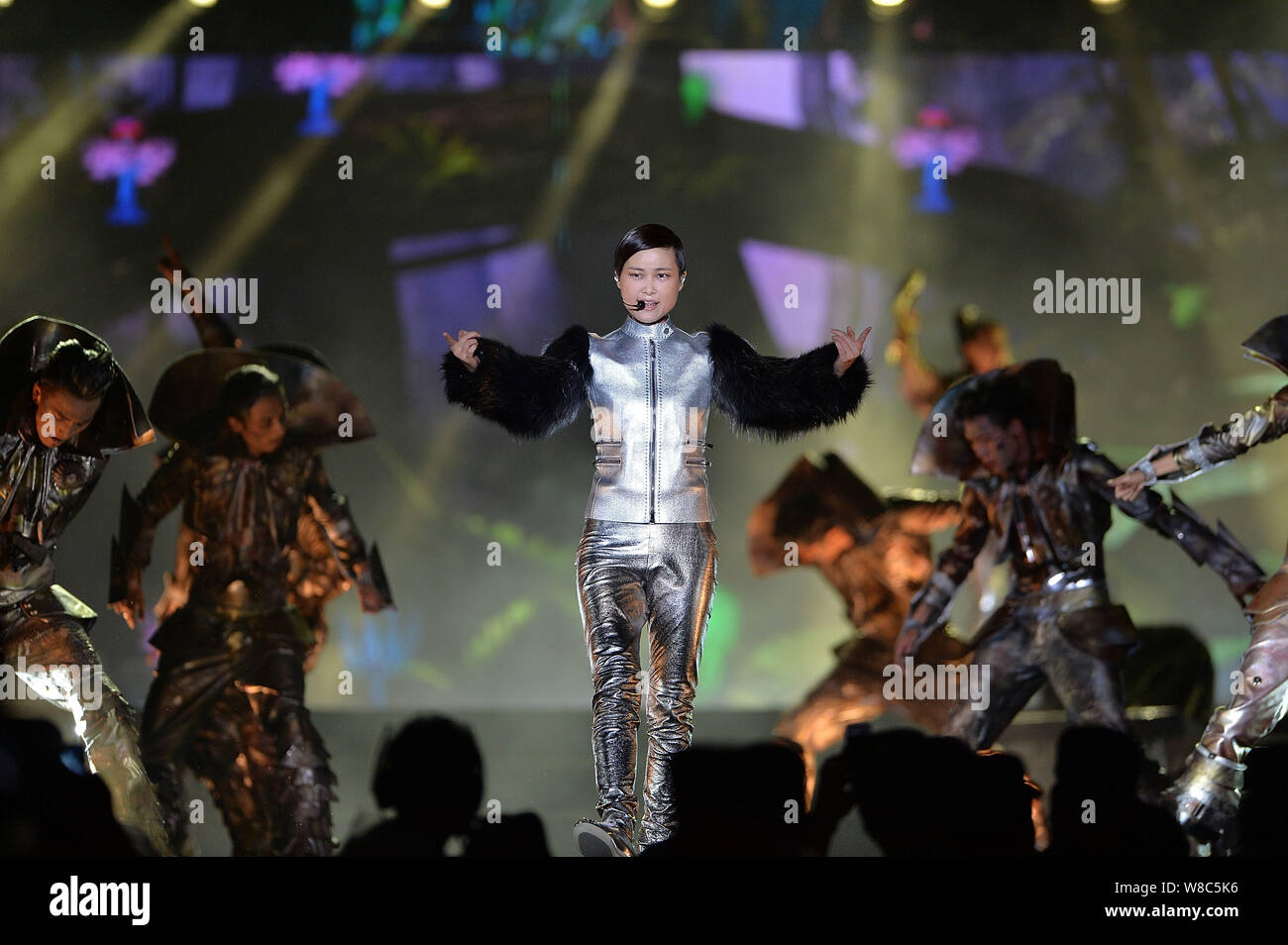 Chinese singer Li Yuchun, center, performs during her "Why Me" concert ...