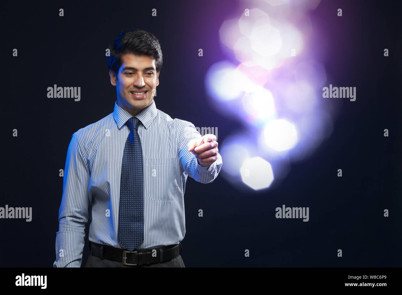 Young smiling businessman pointing hi-res stock photography and images ...