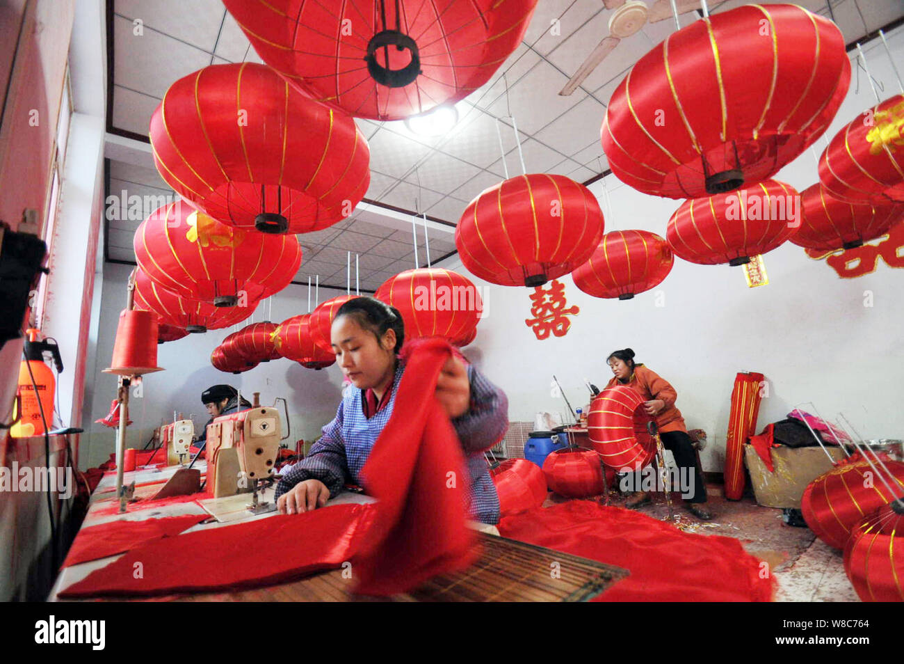 Female Chinese workers make red lanterns at a lantern factory in ...