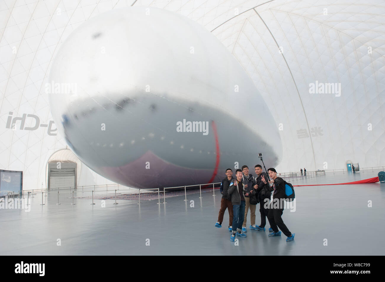 --FILE--Visitors pose for photos in front of the flying platform "Cloud ...