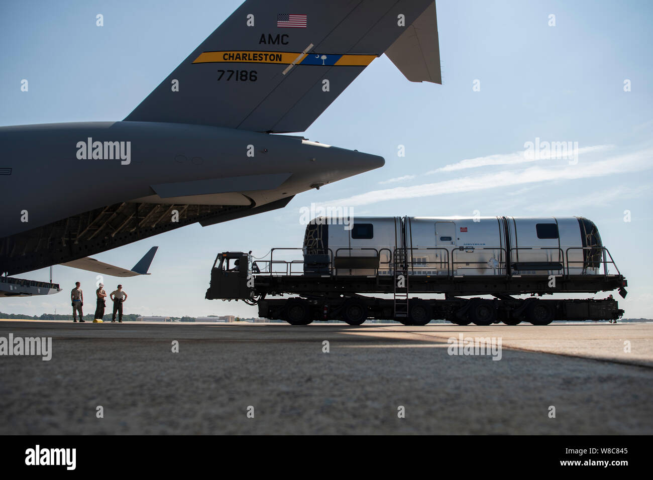 Airmen from the 89th Aerial Port Squadron load a Silver Bullet into a C ...