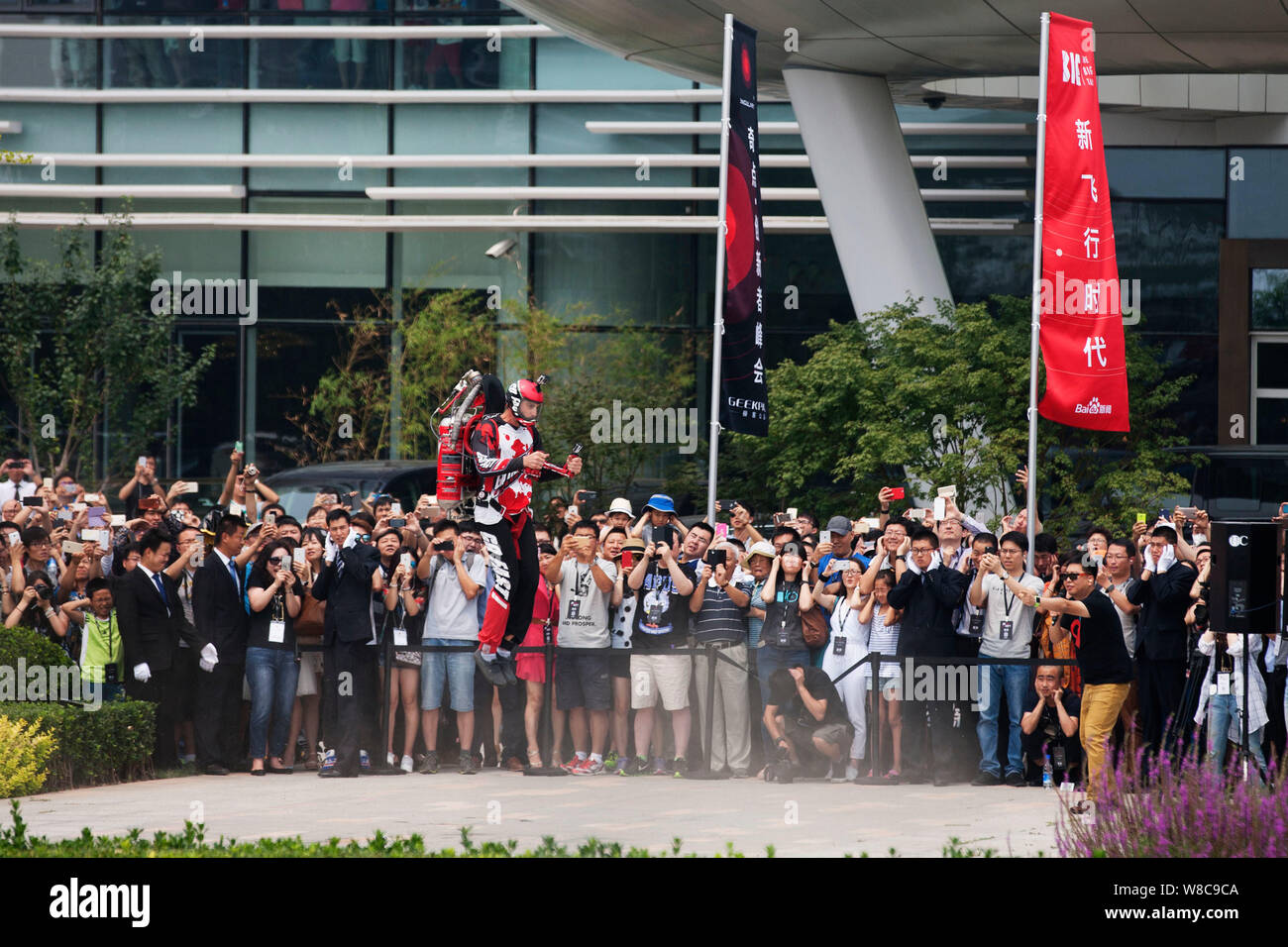 Spectators watch the hydrogen peroxide-powered jetpack propelling pilot ...