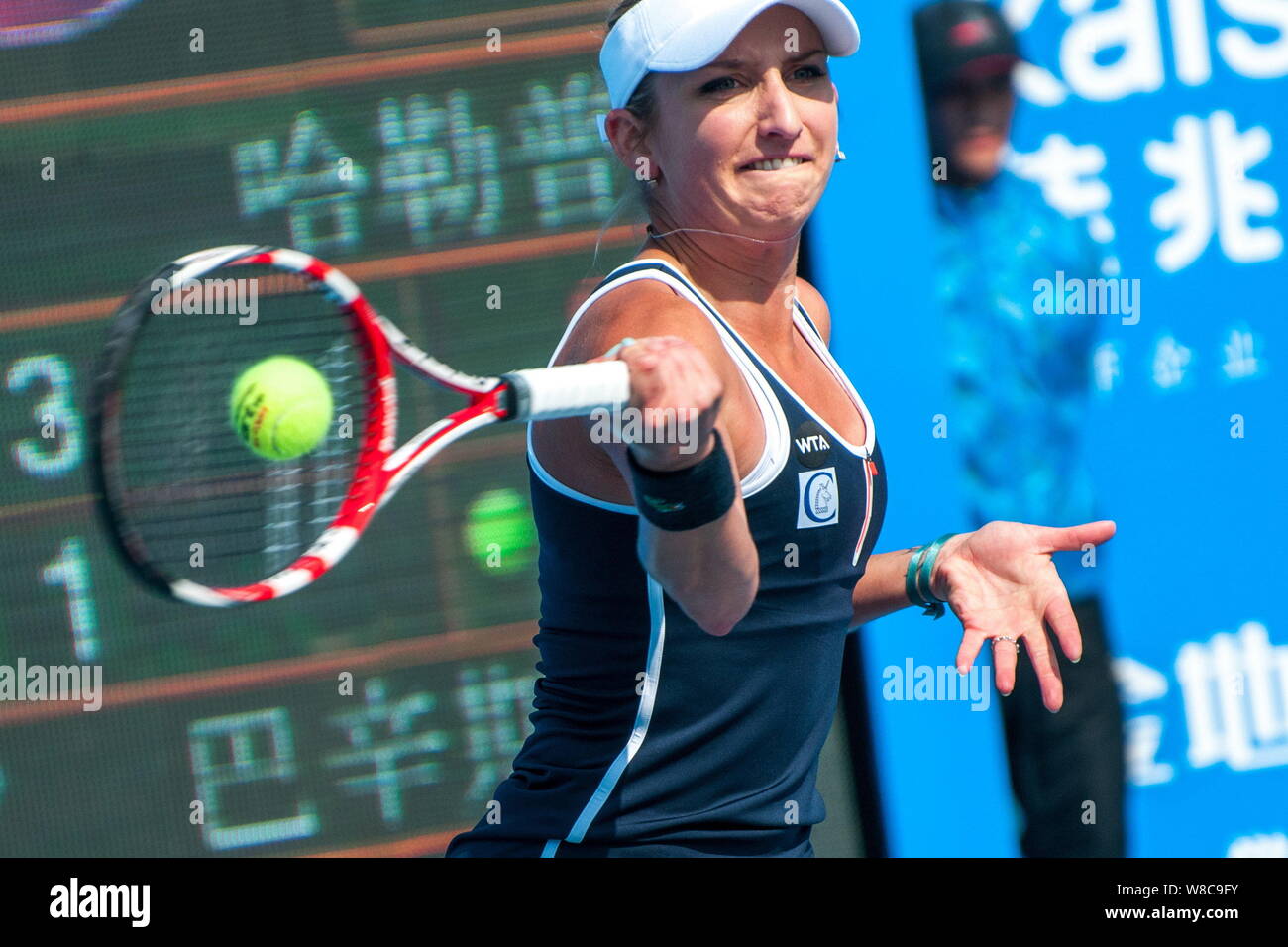 Timea Bacsinszky of Switzerland returns a shot to Simona Halep of Romania in their women's ...