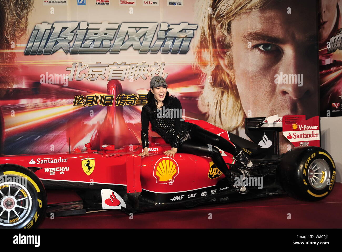 Canadian actress Christy Chung poses leaning on a Ferrari Formula One ...