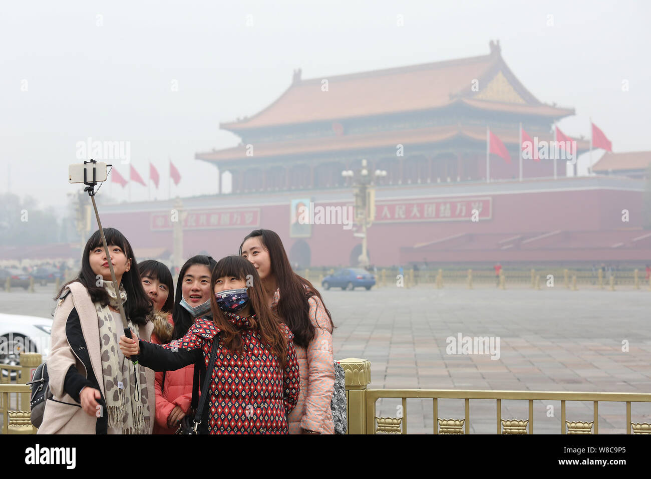 Tourists take a selfie on Tiananmen Square in heavy smog in Beijing ...