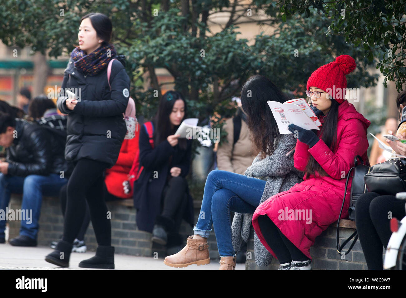 Chinese examinees review textbooks outside a teaching building at ...