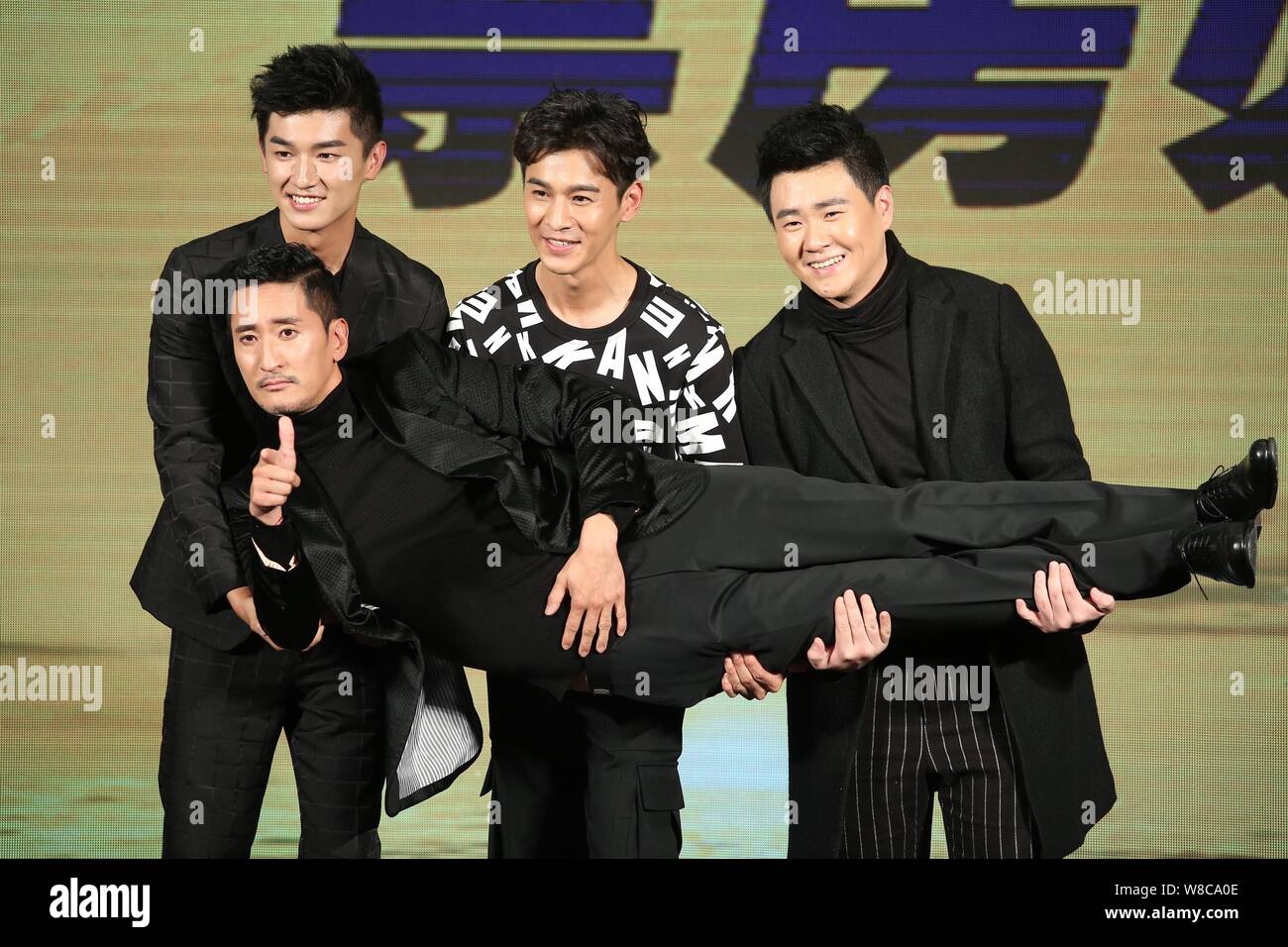 South Korean actor Shin Hyun-joon, front, is held by (from left ...