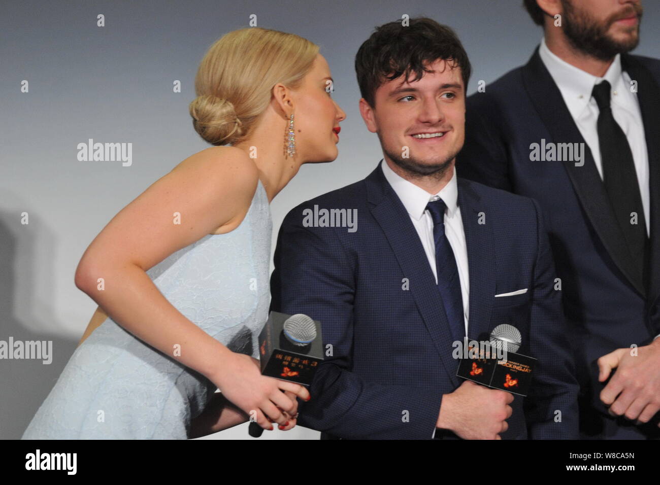 American actress Jennifer Lawrence, left, murmurs with actor Josh ...