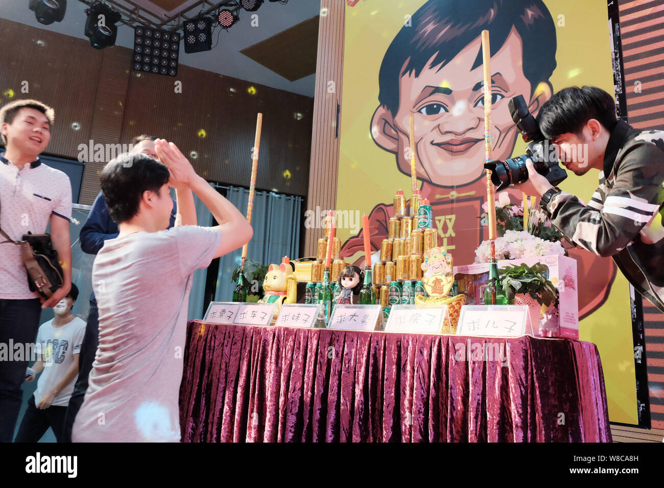 A Chinese employee of an e-commerce company kneels down in front of a ...