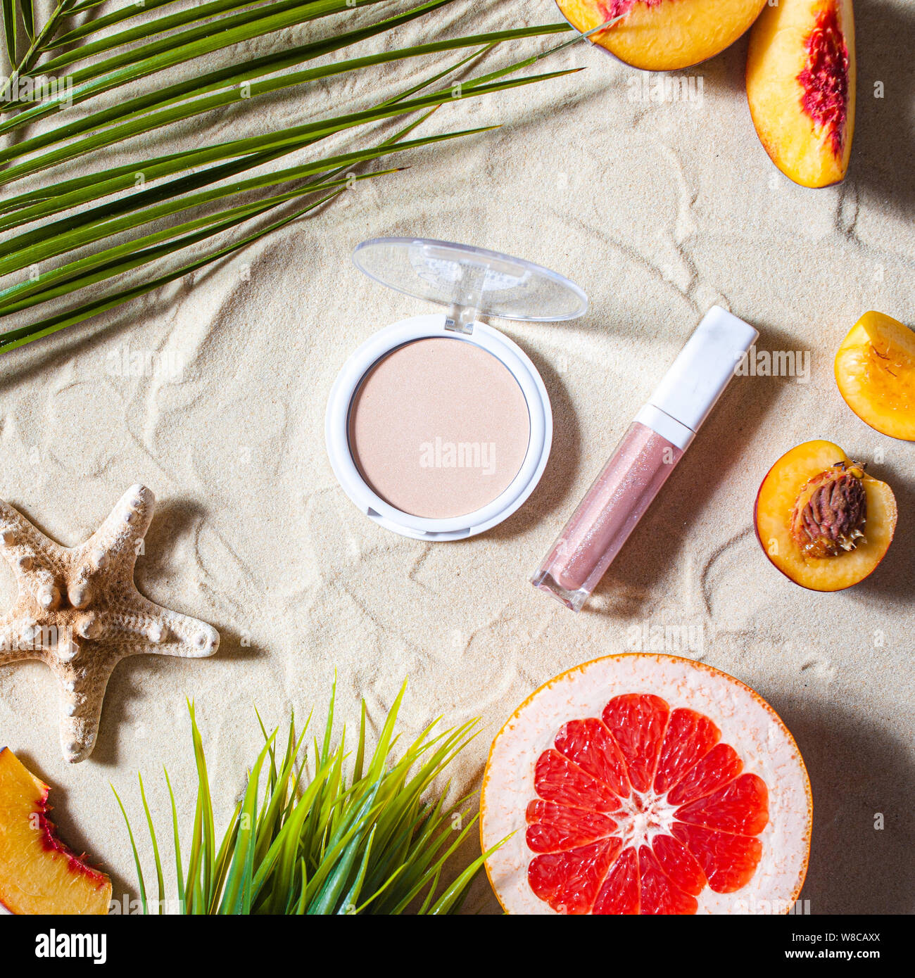 Charming beach. Decorative cosmetics in pastel colors, powder, base ...