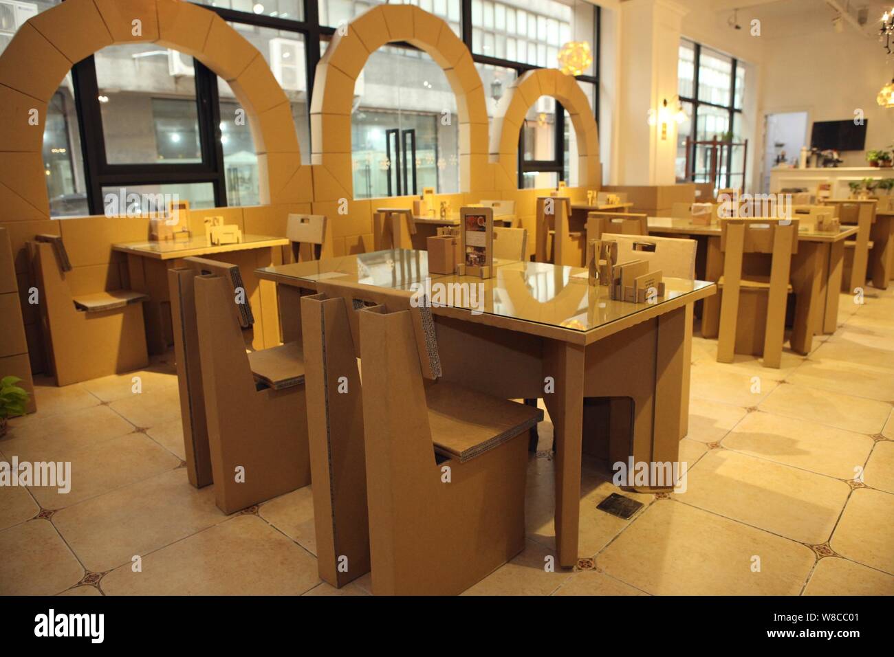 Tables and chairs made of corrugated paper are pictured in a restaurant ...
