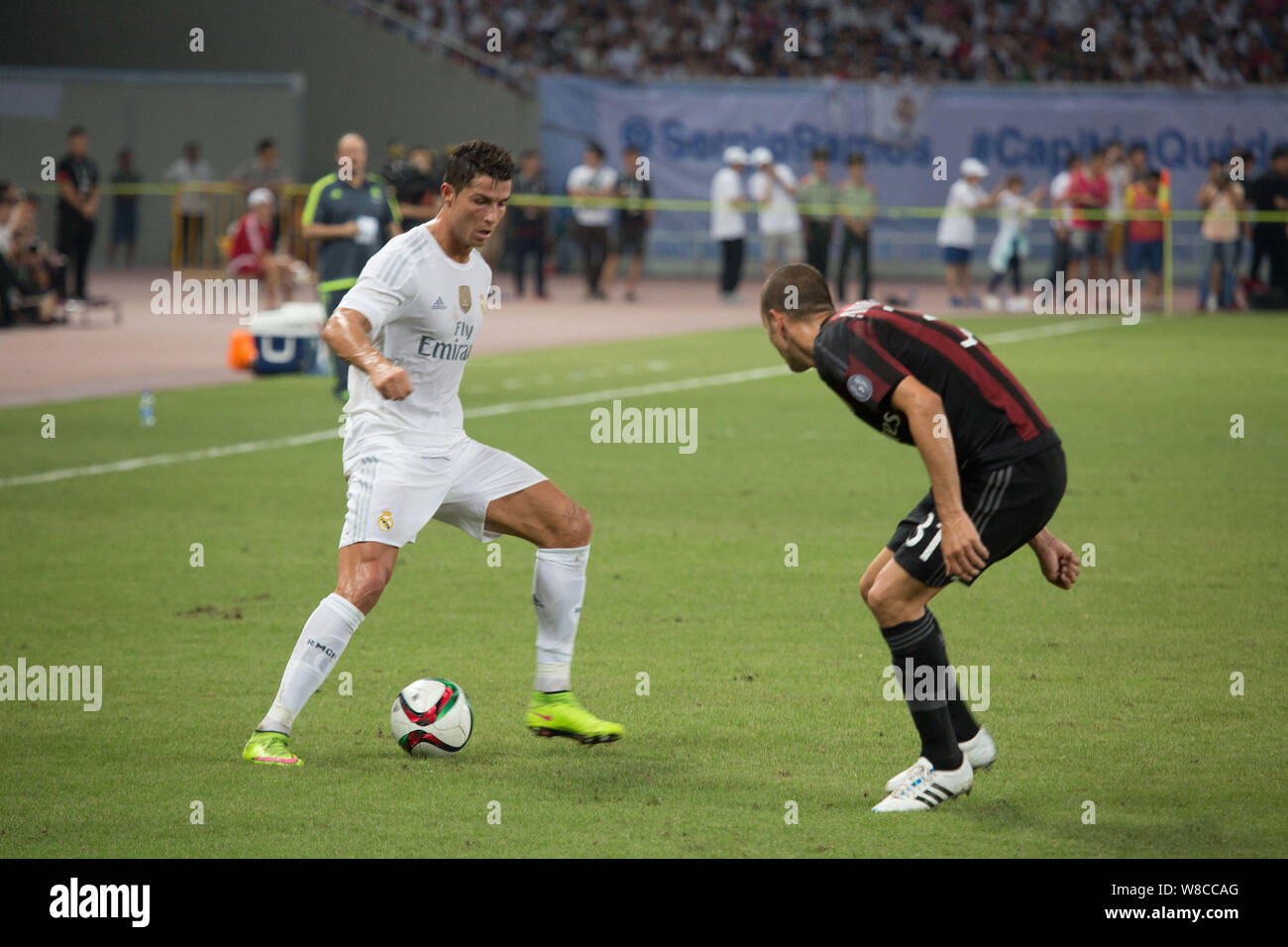 Cristiano Ronaldo of Real Madrid, left, challenges Luca Antonelli of AC ...